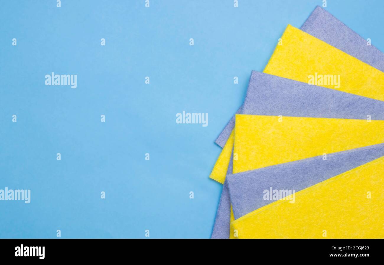 Yellow and blue square rags for cleaning, dusting on a blue background ...