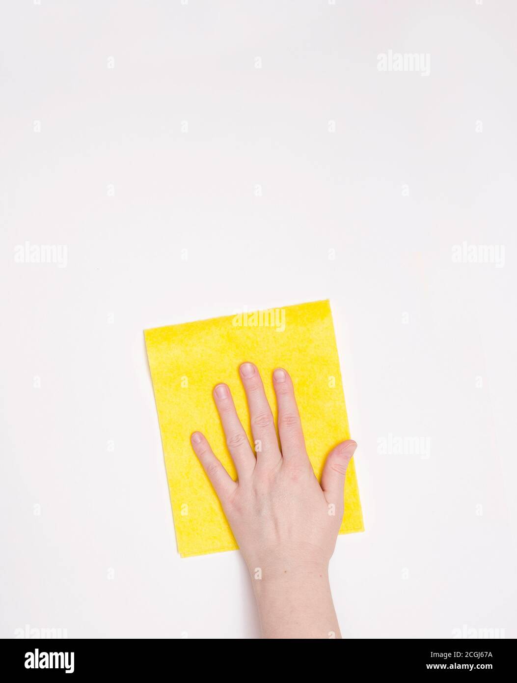 Part of the hand with a yellow cloth for dusting and removing dirt ...
