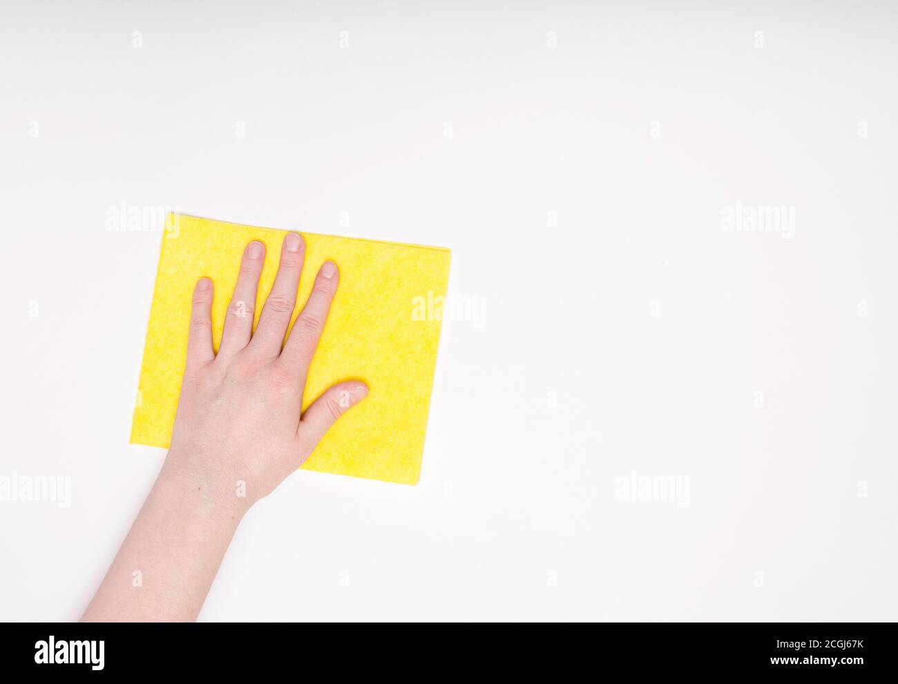 Part of the hand with a yellow cloth for dusting and removing dirt ...