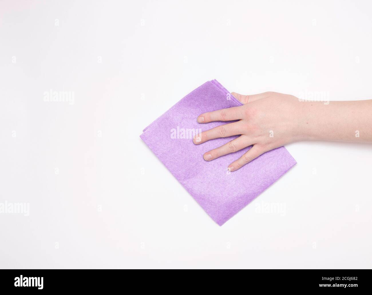 Part of the hand with a purple cloth for dusting and removing dirt ...