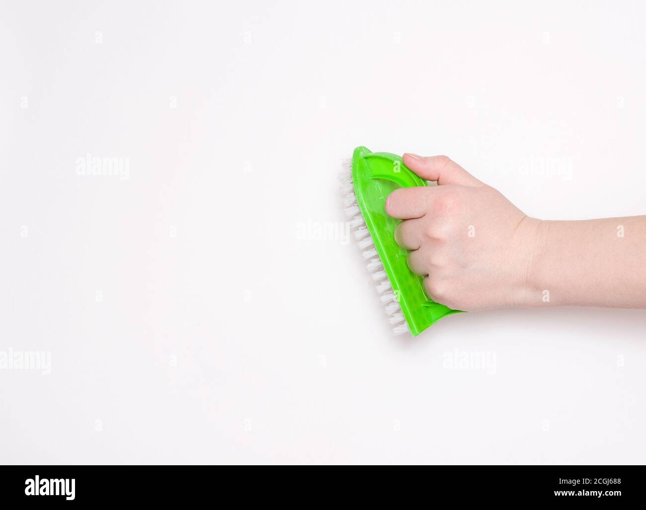 Part of the hand with a brush to remove dirt. Cleaning, white ...