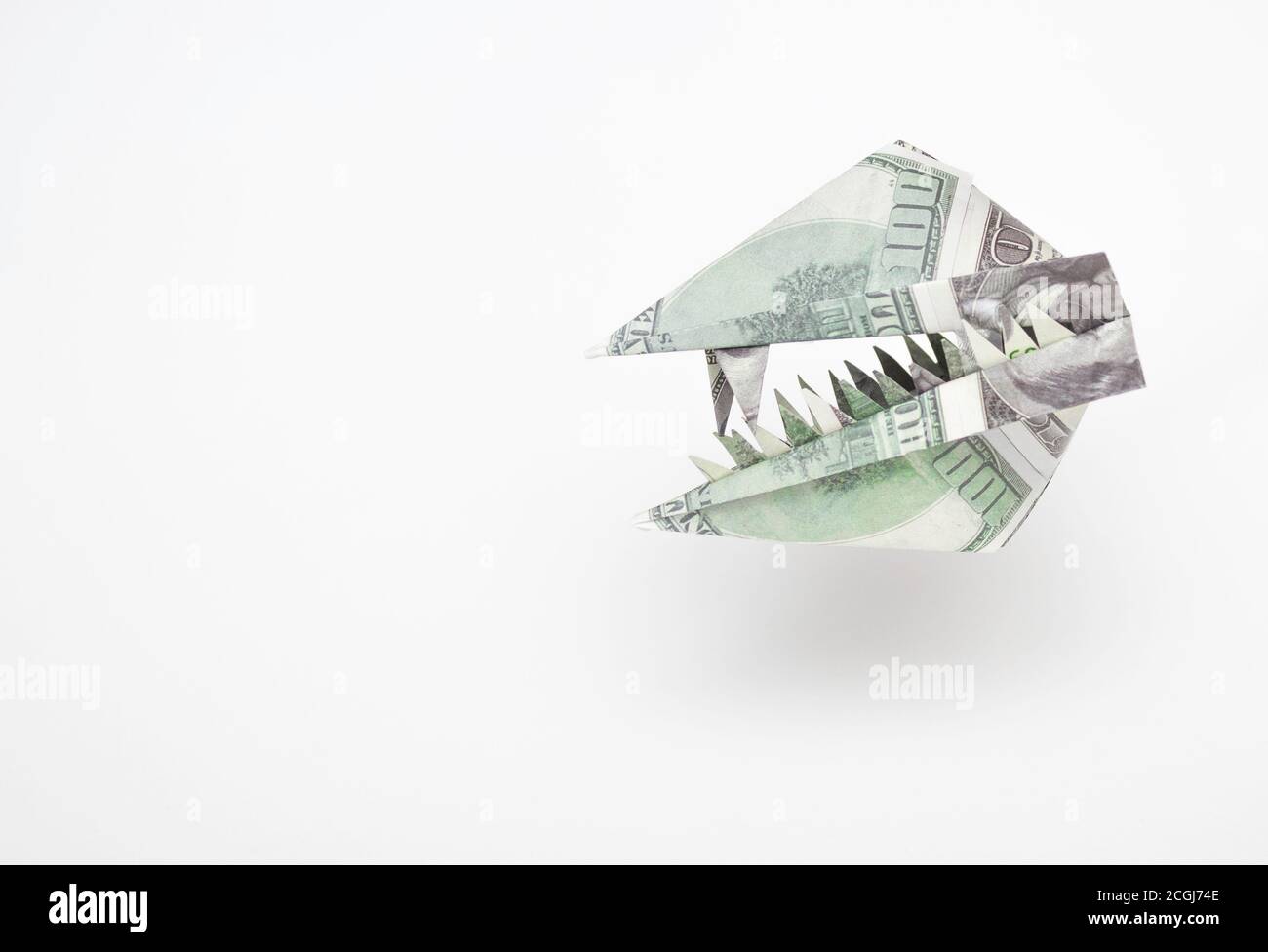 Dollar bills in the form of an animal's head with sharp teeth, origami ...