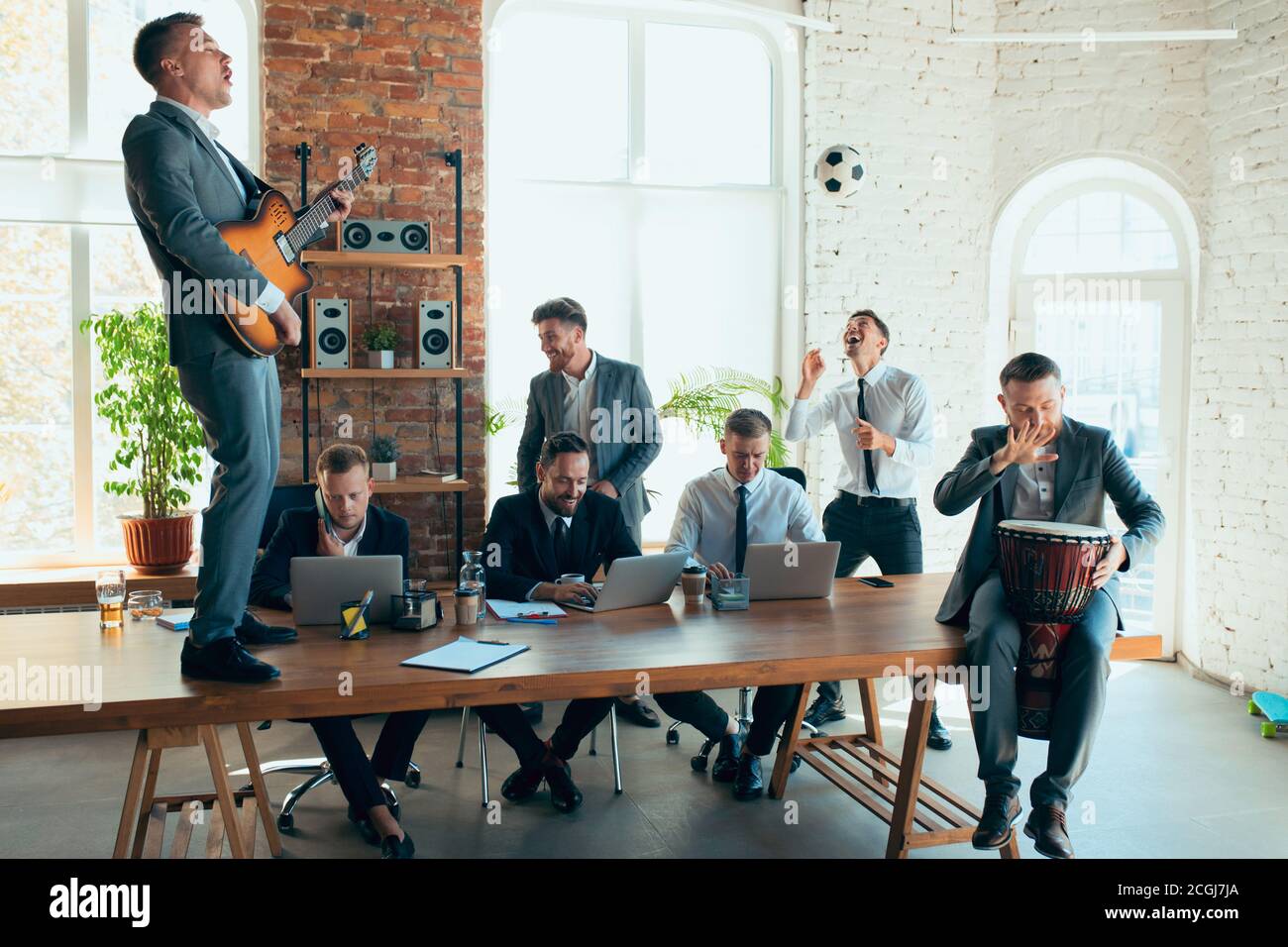 Singing, giving music concert, dancing. Happy carefree colleagues ...