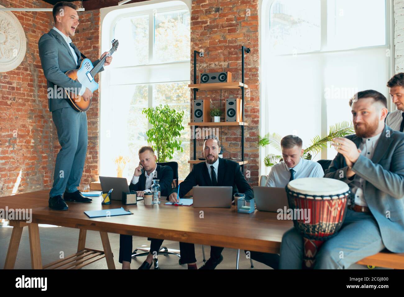 Singing, giving music concert, dancing. Happy carefree colleagues ...