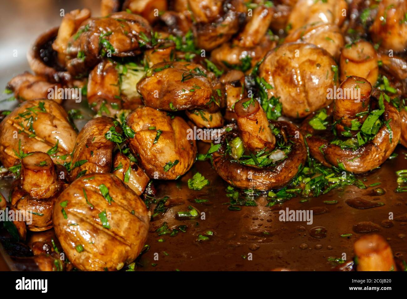 Grilled champignons mushrooms with parsley Stock Photo - Alamy