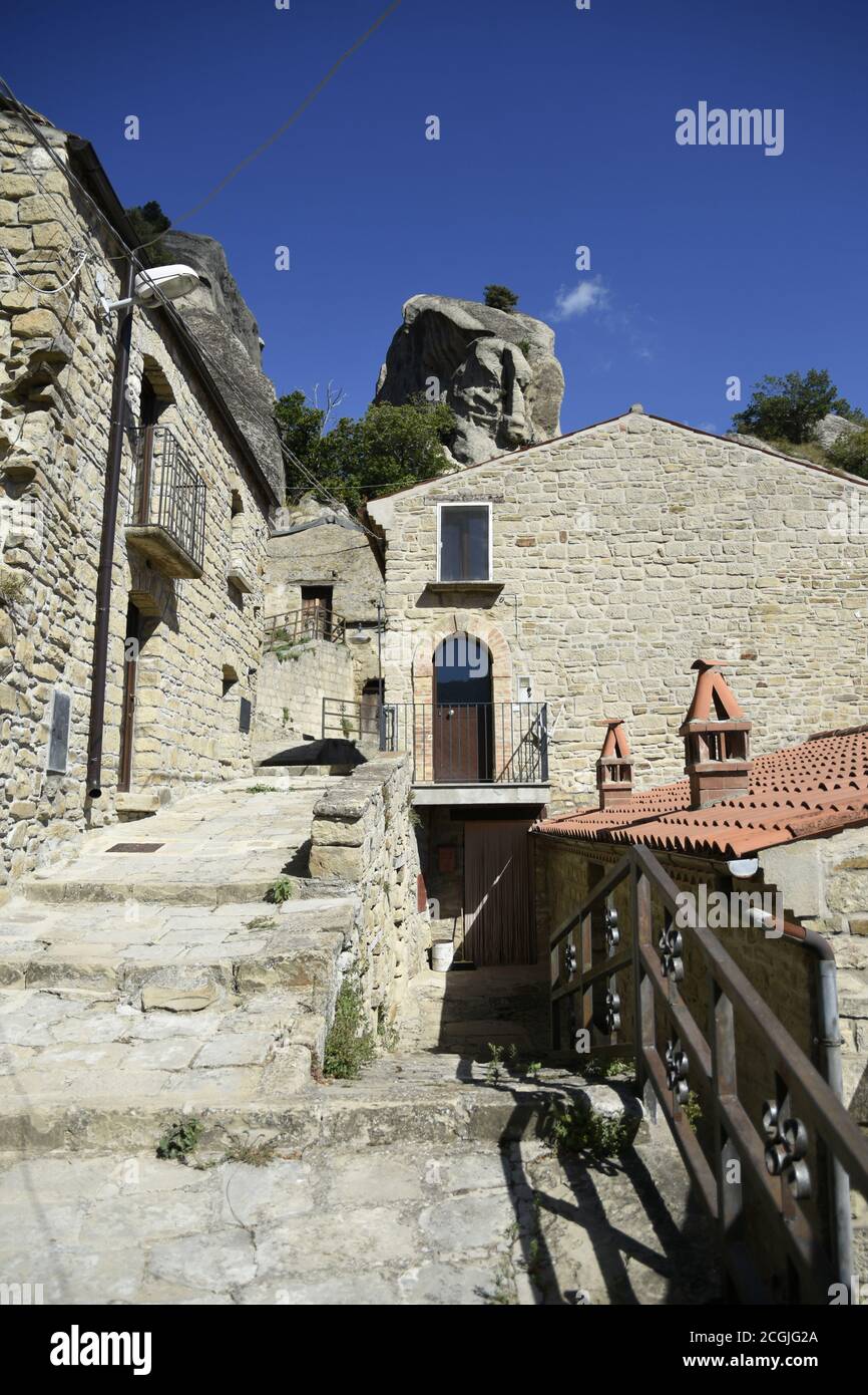 A narrow street among the old houses of Castelmezzano, a rural village ...