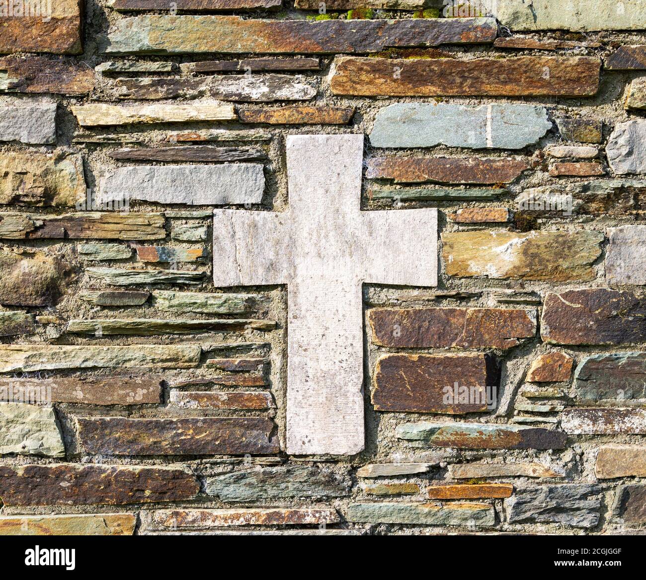 Stone cross in stone wall Stock Photo - Alamy