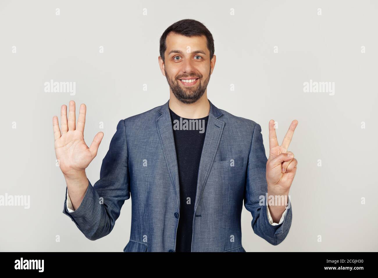 Young businessman man with beard smiling, showing number seven with ...