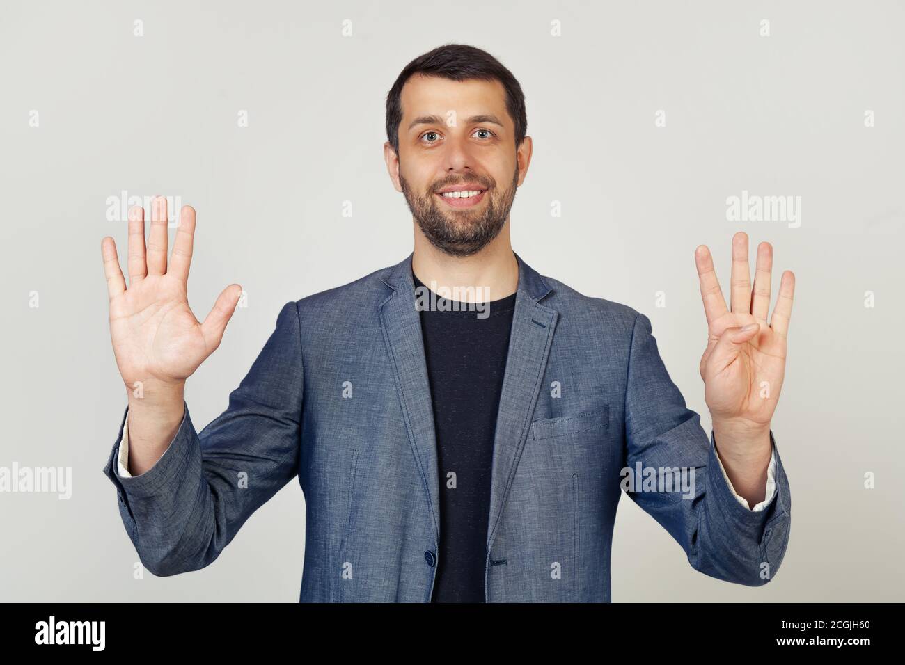 Young businessman man with beard smiling, showing number nine with ...