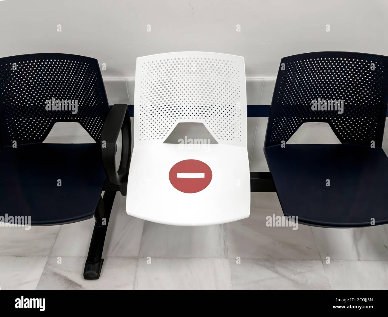Social distance concept. Red symbol sticker placed on a chair in the ...
