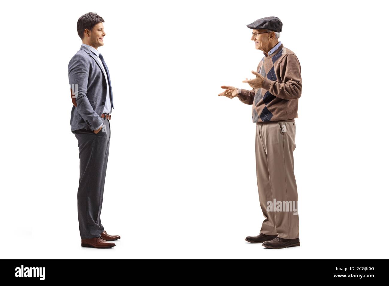 Full length profile shot of an elderly man talking to a young man in ...