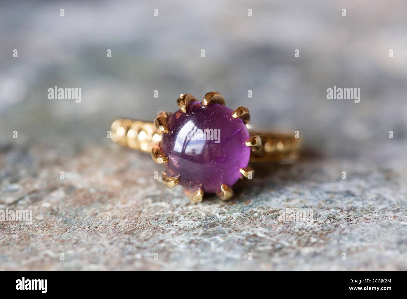 Brass metal decorative ring with natural mineral amethyst gemstone on ...