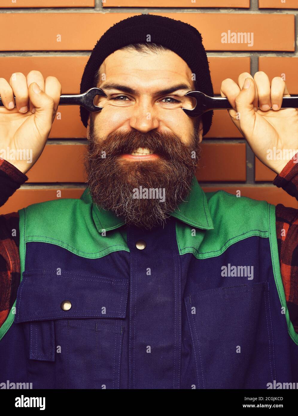 Bearded man, long beard. Brutal caucasian smiling happy mechanic ...