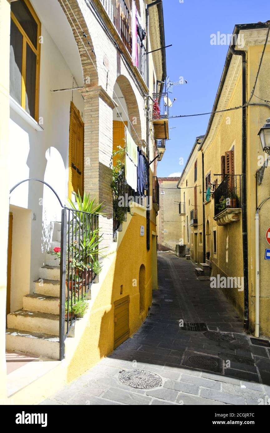 A narrow street among the old houses of Calvello, a rural village in ...