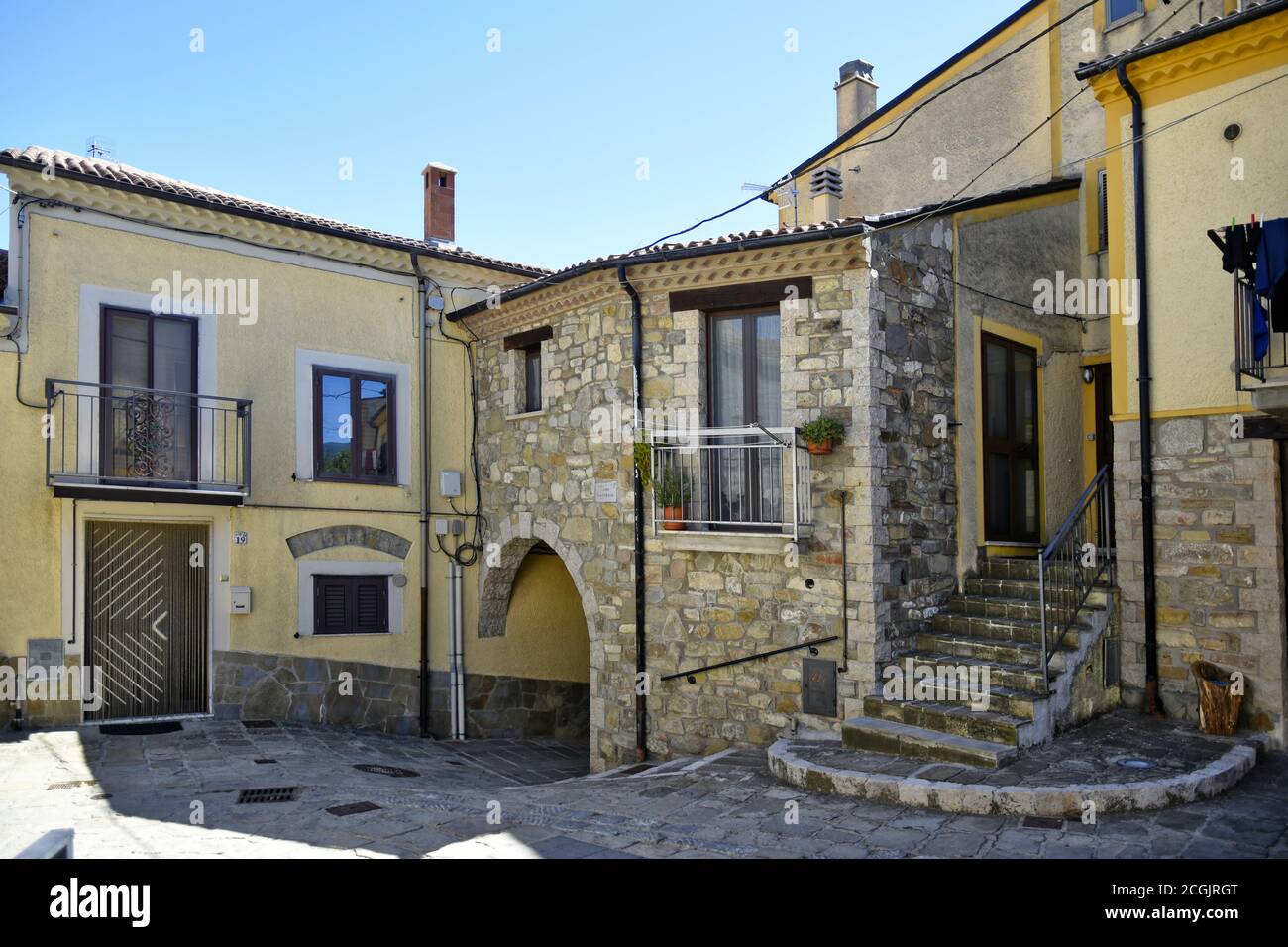 A narrow street among the old houses of Calvello, a rural village in ...
