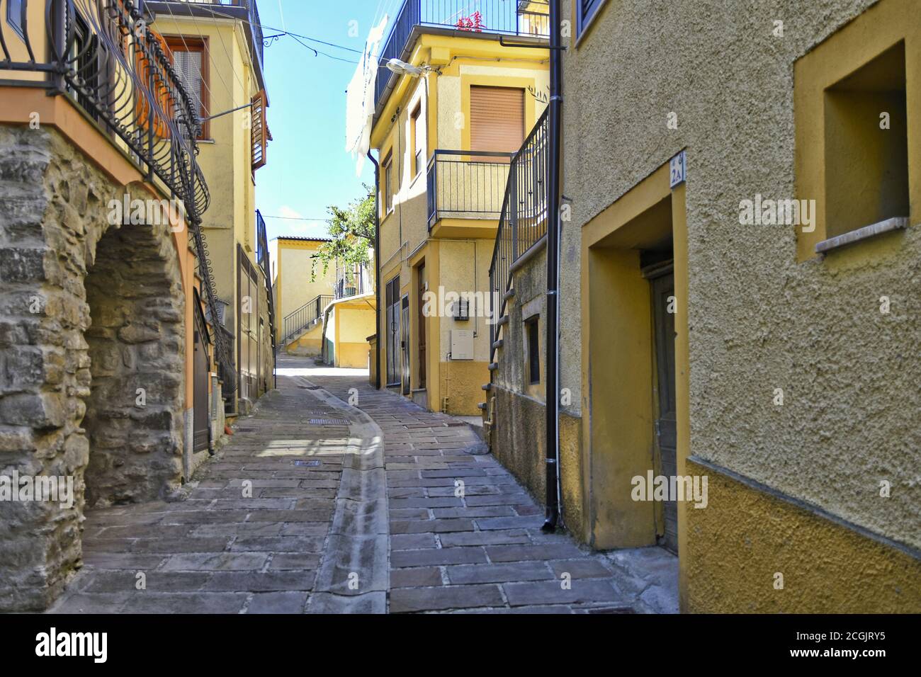 A narrow street among the old houses of Calvello, a rural village in ...