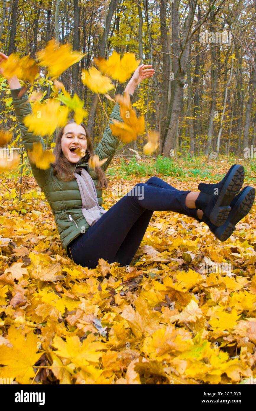 Autumn nature background. Autumn leaves falling on happy laughing young ...