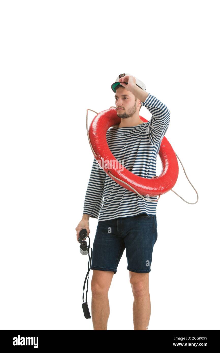 Holding lifeline and binocular. Caucasian male sailor in uniform on ...