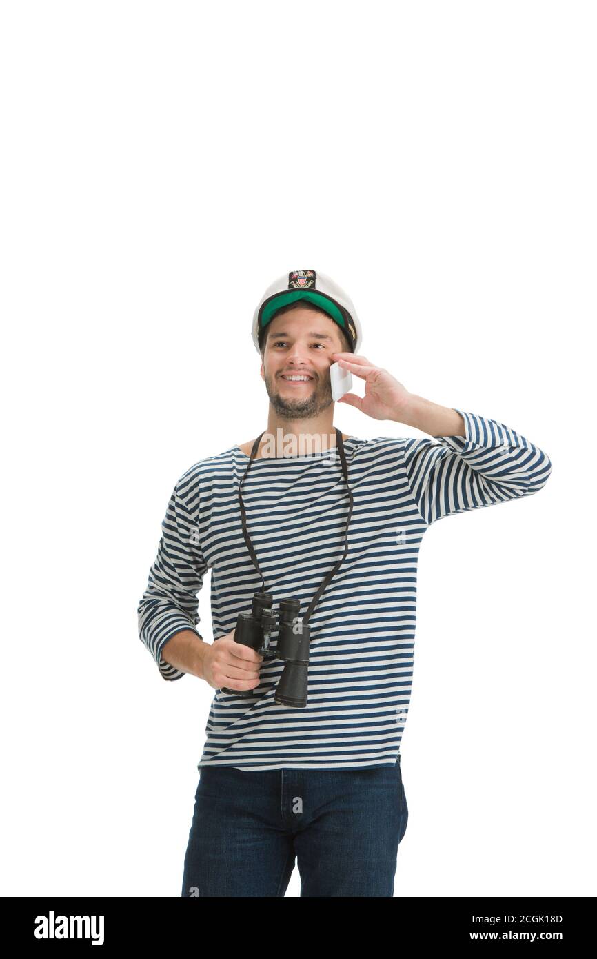 Talking phone. Caucasian male sailor in uniform on white studio ...