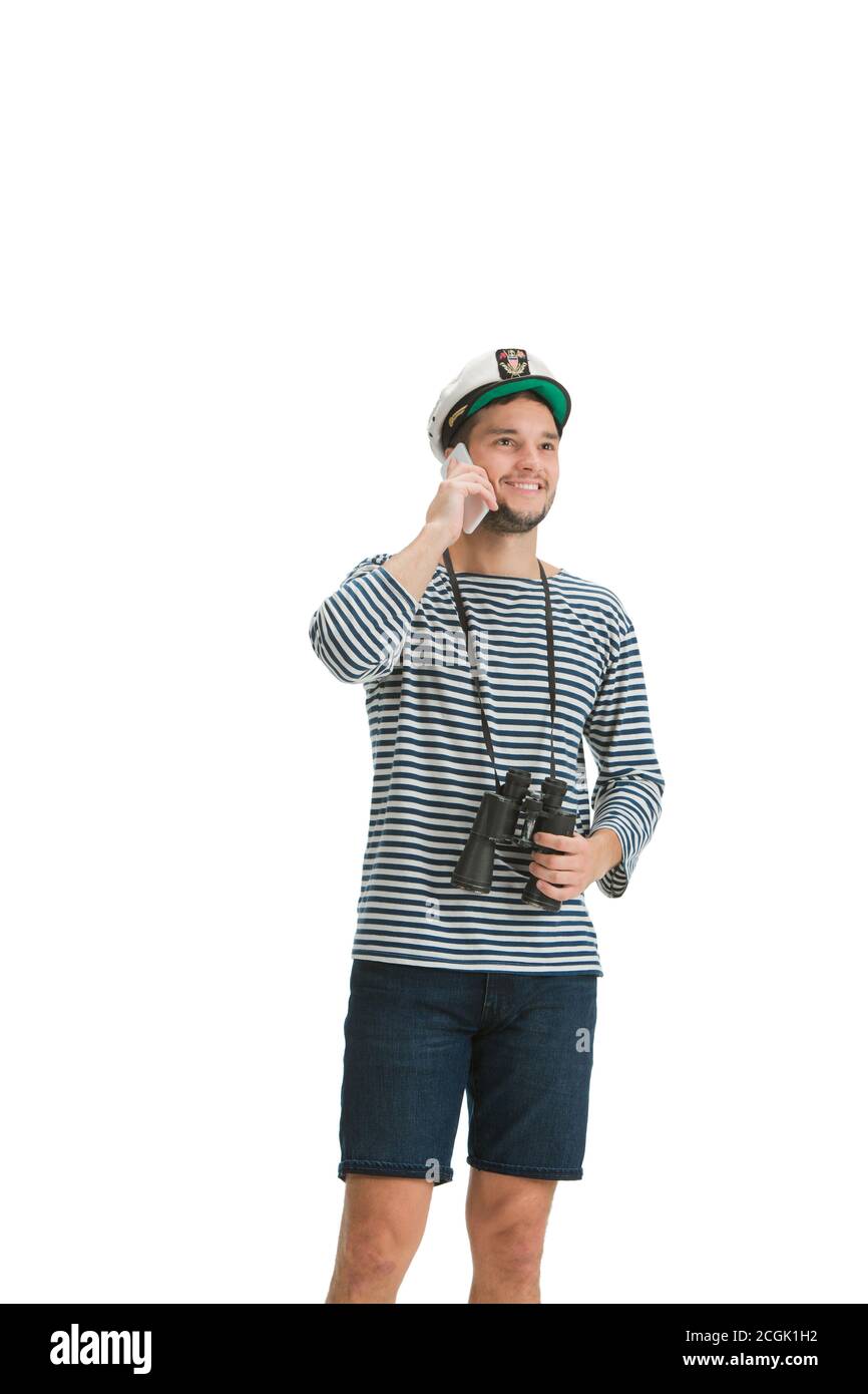 Talking phone. Caucasian male sailor in uniform on white studio ...
