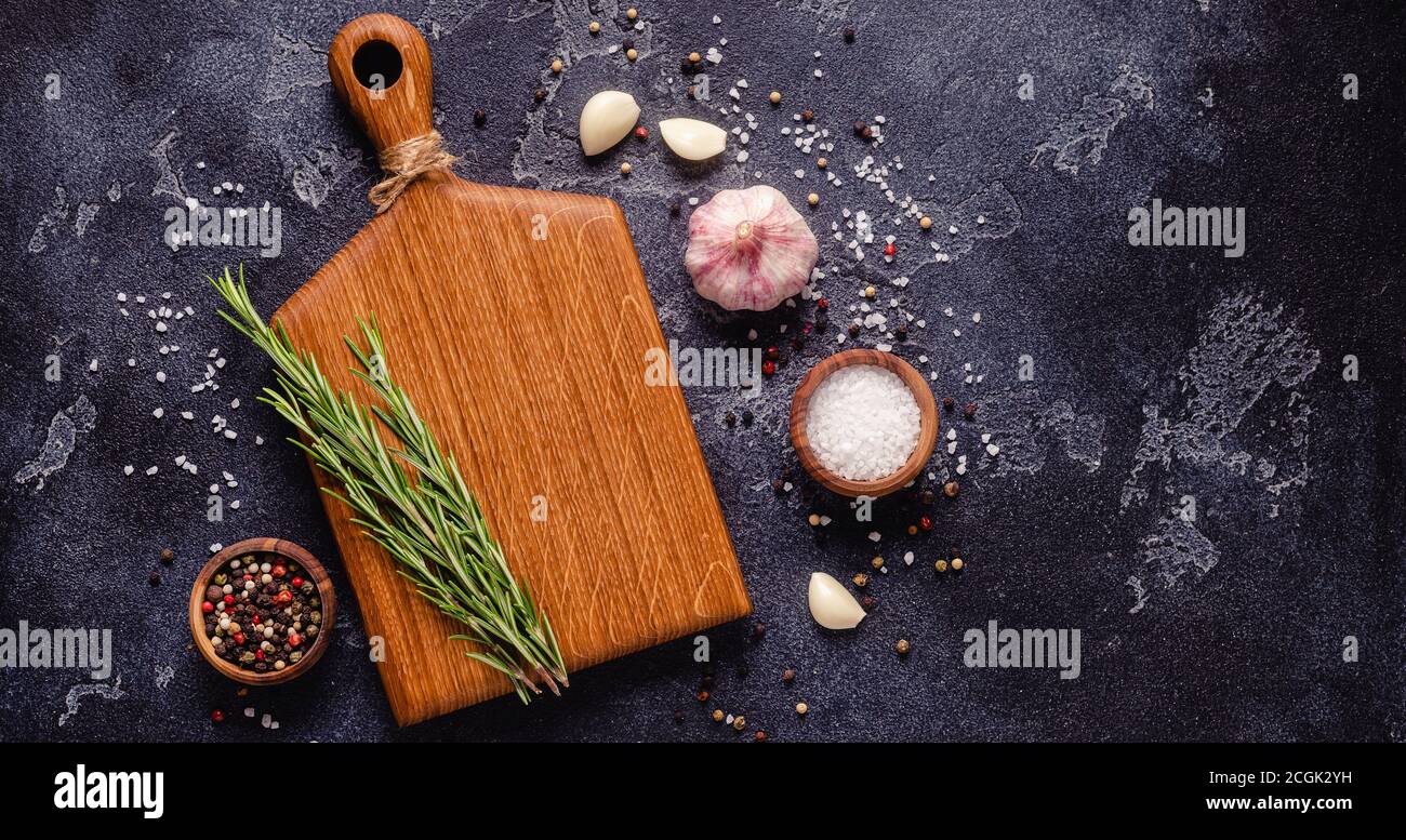 Herbs and condiments on black stone background. Top view with copy ...