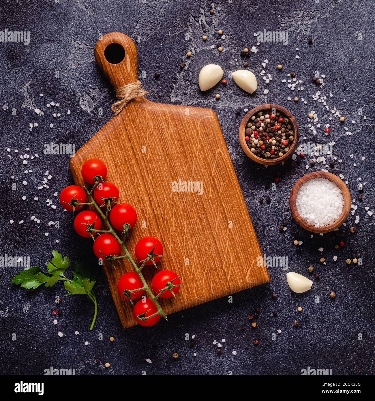 Herbs and condiments on black stone background. Top view with copy ...