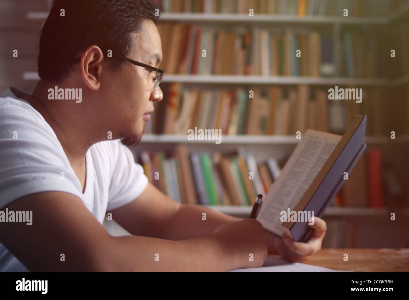 Asian man reading book in library, educational concept. Happy smiling ...