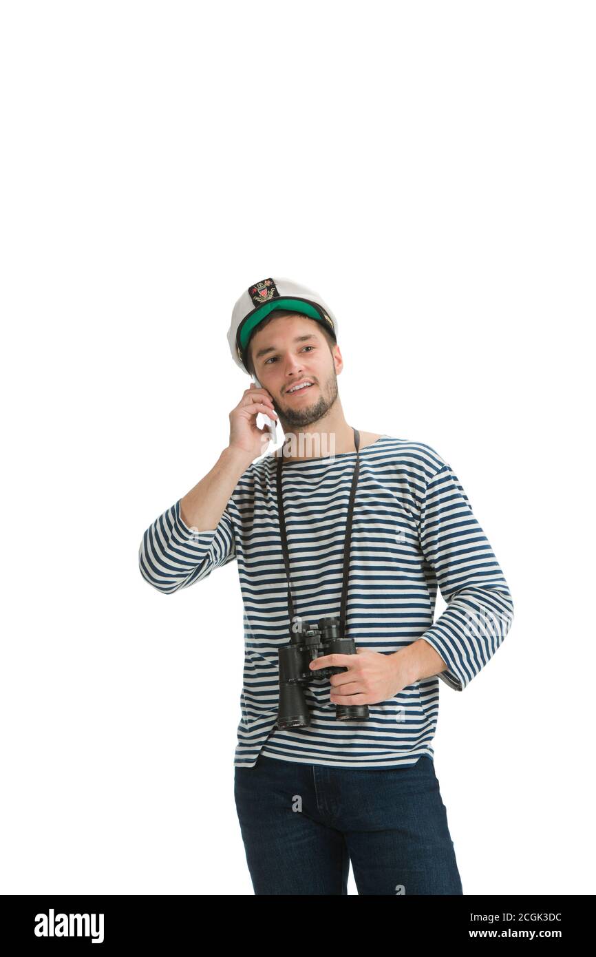 Talking phone. Caucasian male sailor in uniform on white studio ...