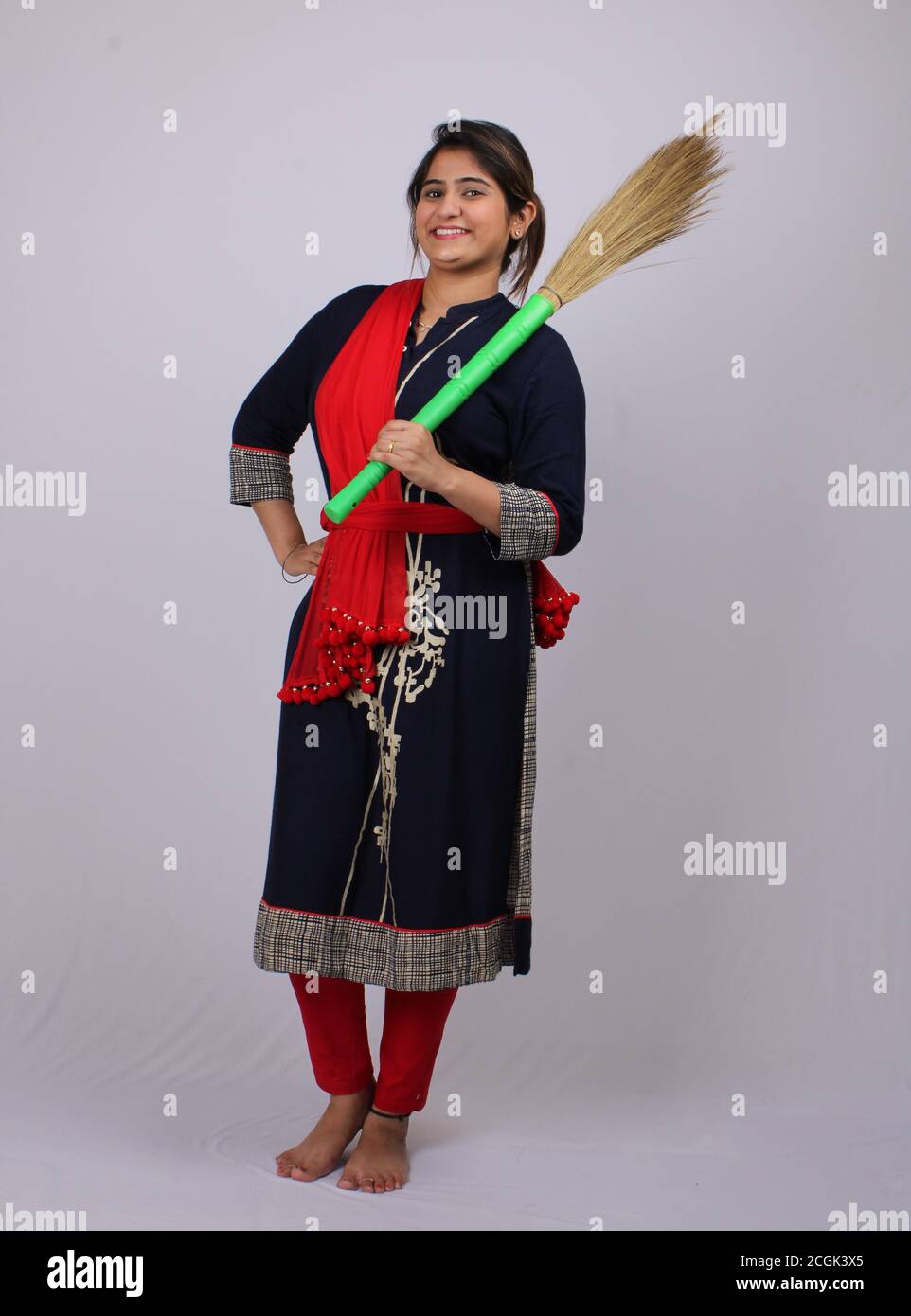 Young asian woman of indian origin with a sweeping broom Stock Photo ...