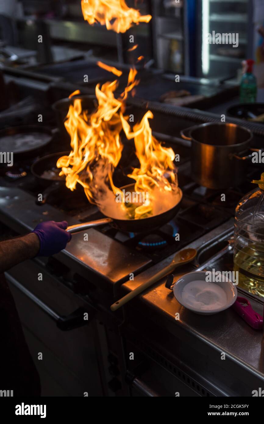 Cooking on fire in the restaurant kitchen Stock Photo - Alamy