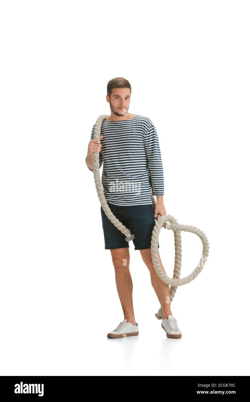 Pulls the rope, tug of war. Caucasian male sailor in uniform on white ...