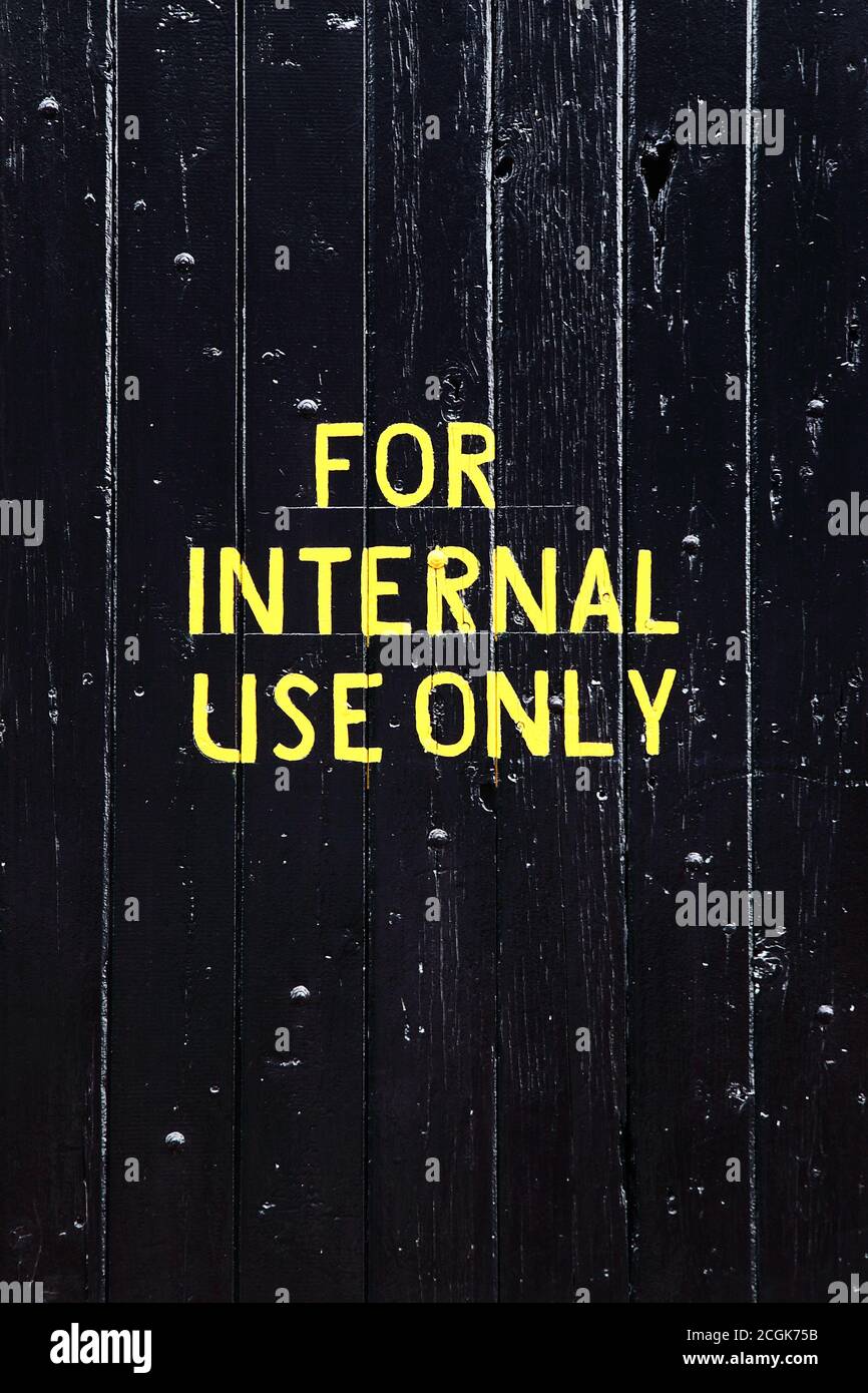 For internal use only text, yellow, on black wood Stock Photo - Alamy