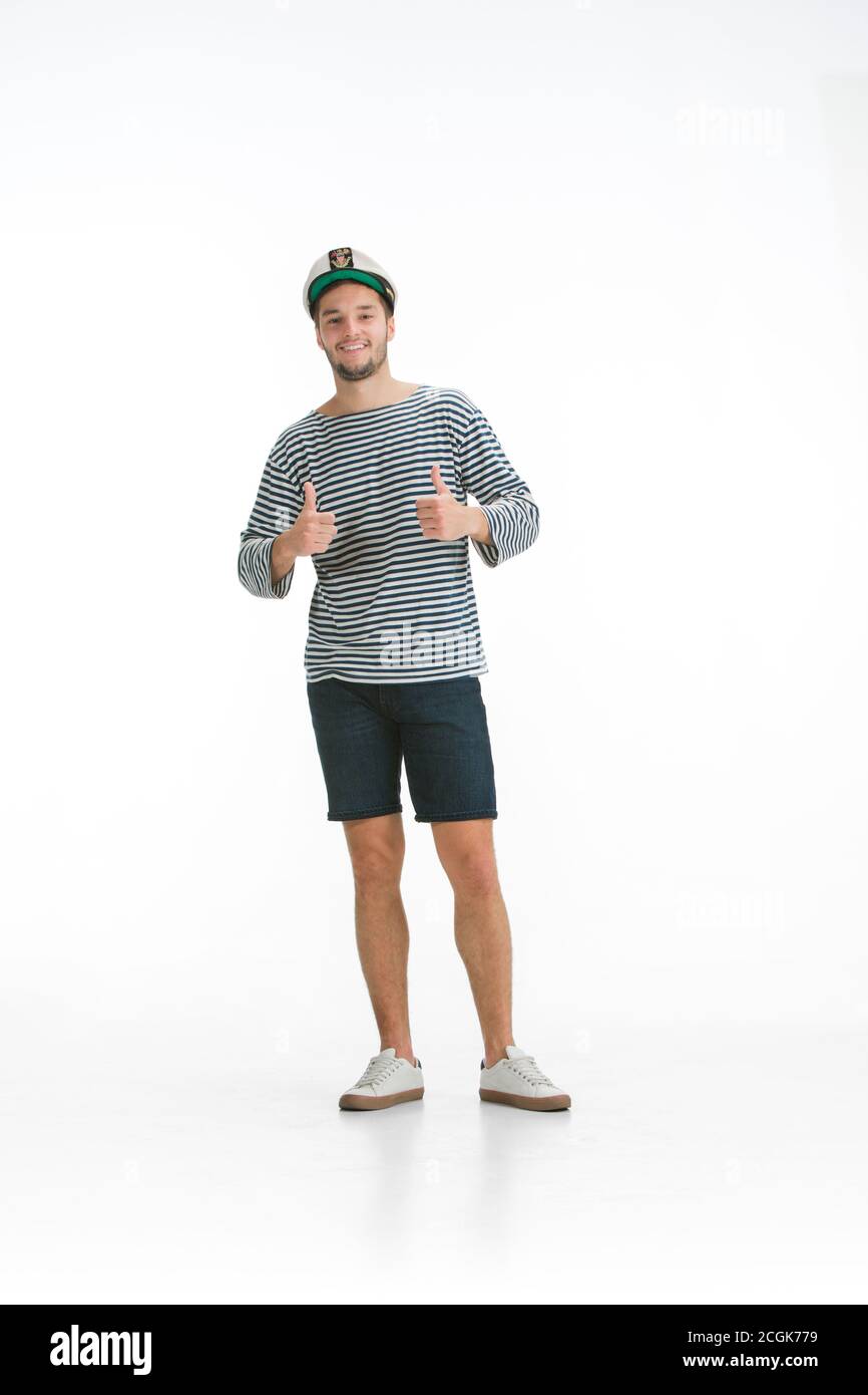 Thumbs up, smiling. Caucasian male sailor in uniform on white studio ...