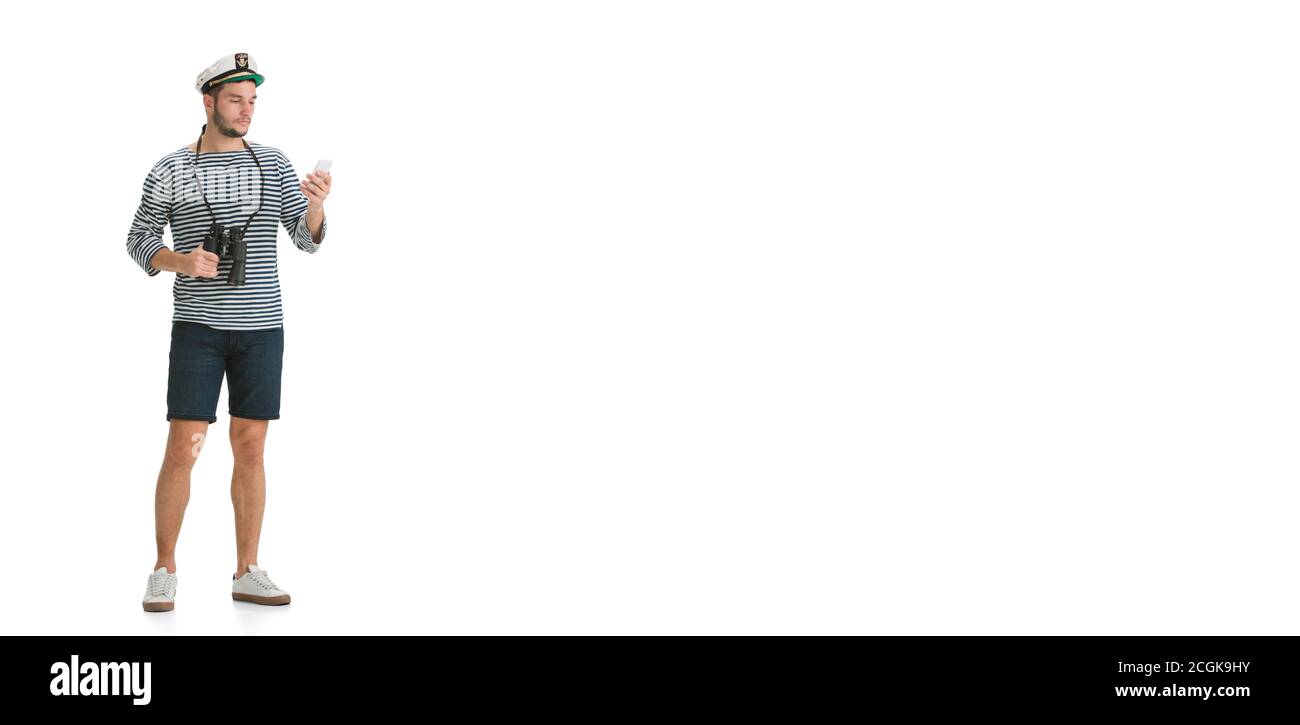 Man with smartphone. Caucasian male sailor in uniform on white studio ...
