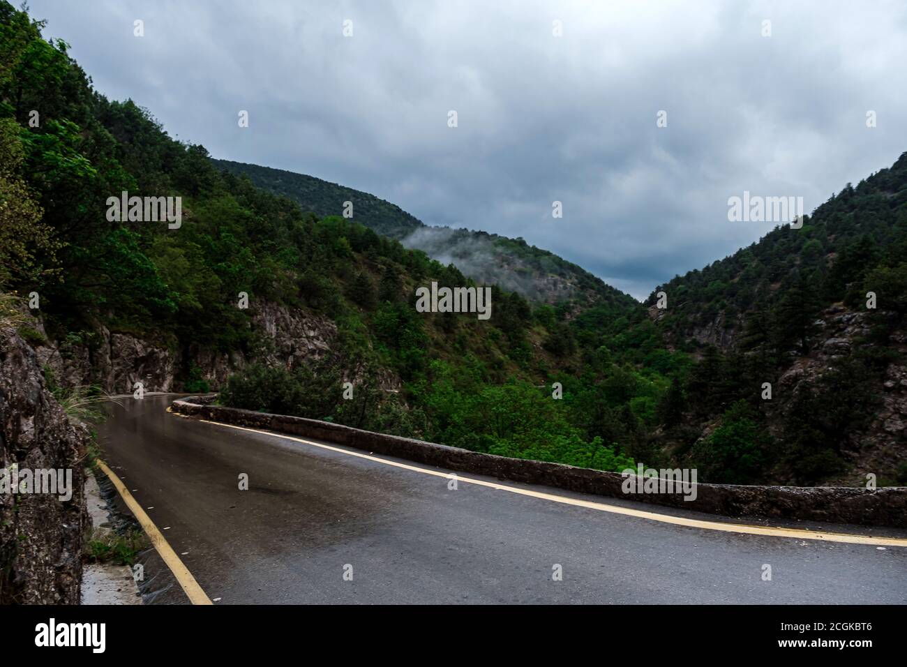 Asphalt road through the mountains forest in rainy season. Road in the ...