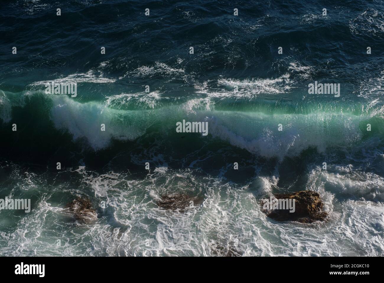 Ocean wave background breaking sea water rocky shore rough seas ...