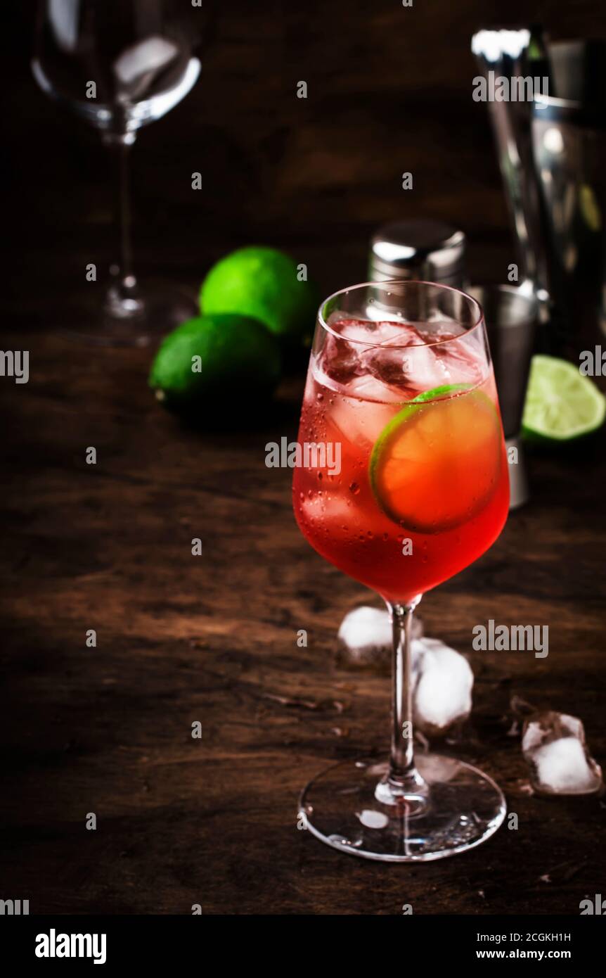 Campari tonic alcoholic cocktail with red bitter, tonic, lime and ice ...