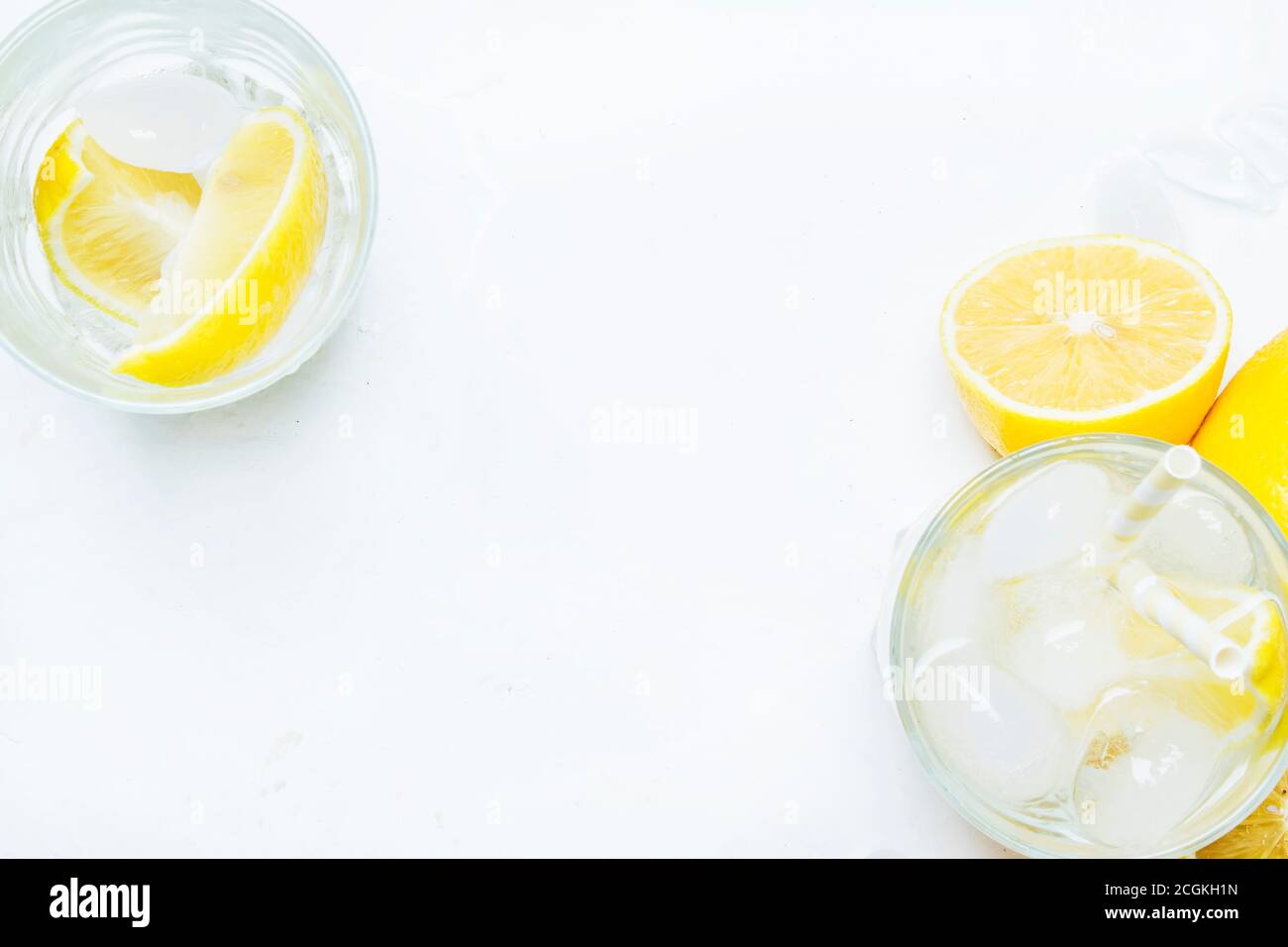 Summer refreshing drink, cold water with ice and lemon, white ...