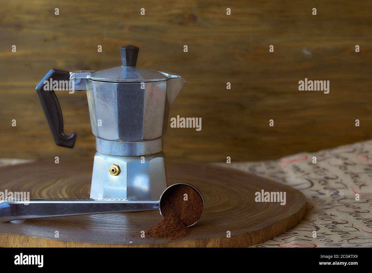 Geyser coffee maker on a wooden tray. With coffee spoon. Dark ...