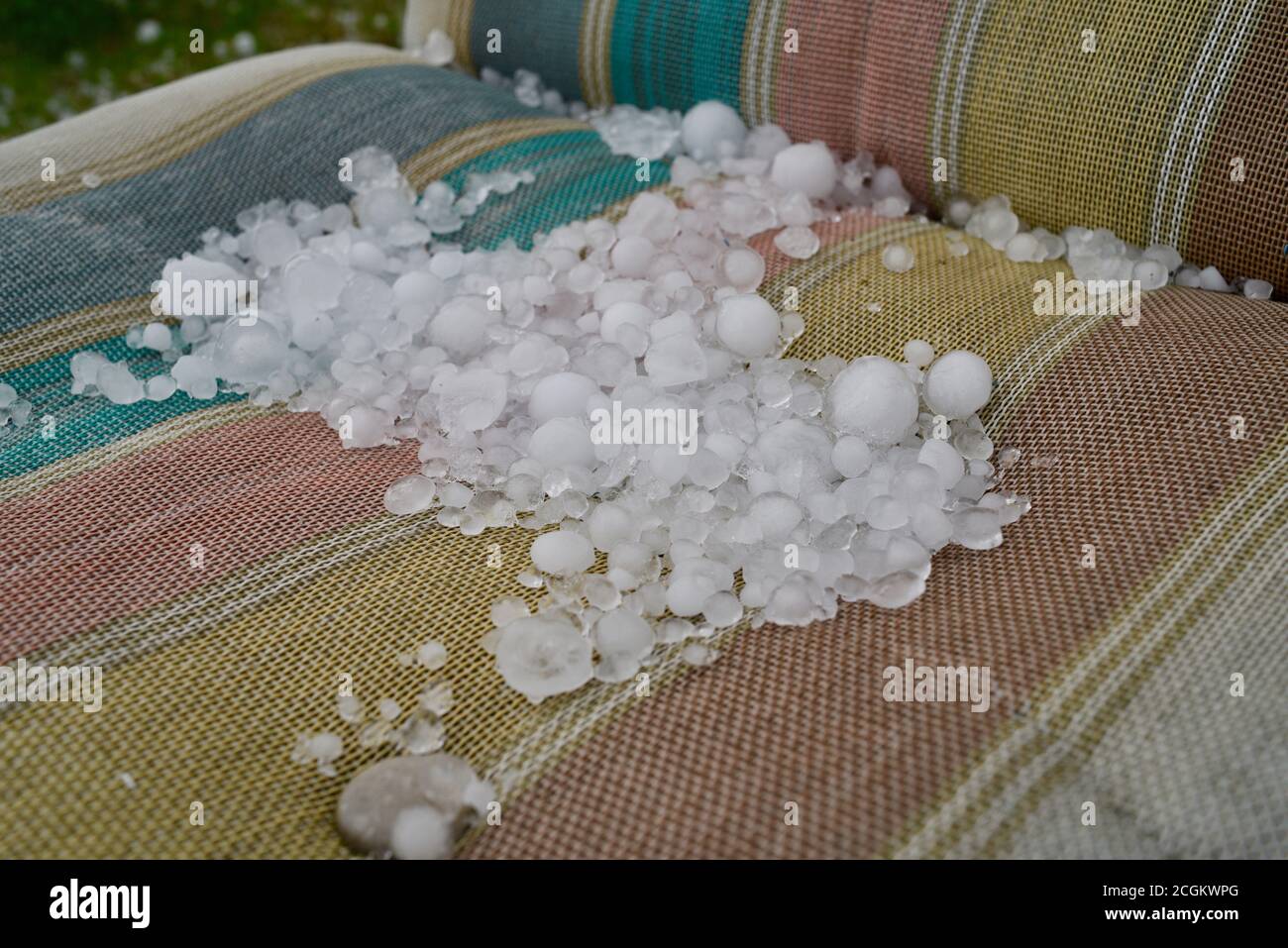 Large hail stones piled up on outdoor lawn furniture after a severe ...
