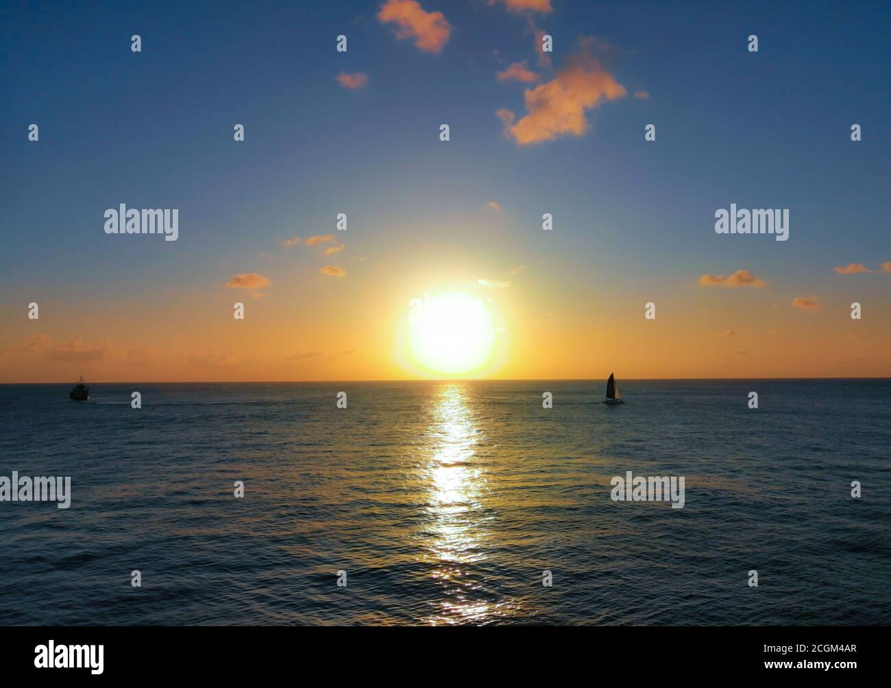 Beautiful sunset with large yellow sun above the sea surface and ...