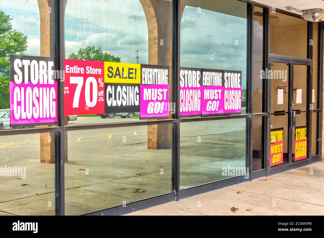 Horizontal shot of Going Out of Business signs in a retail store’s ...