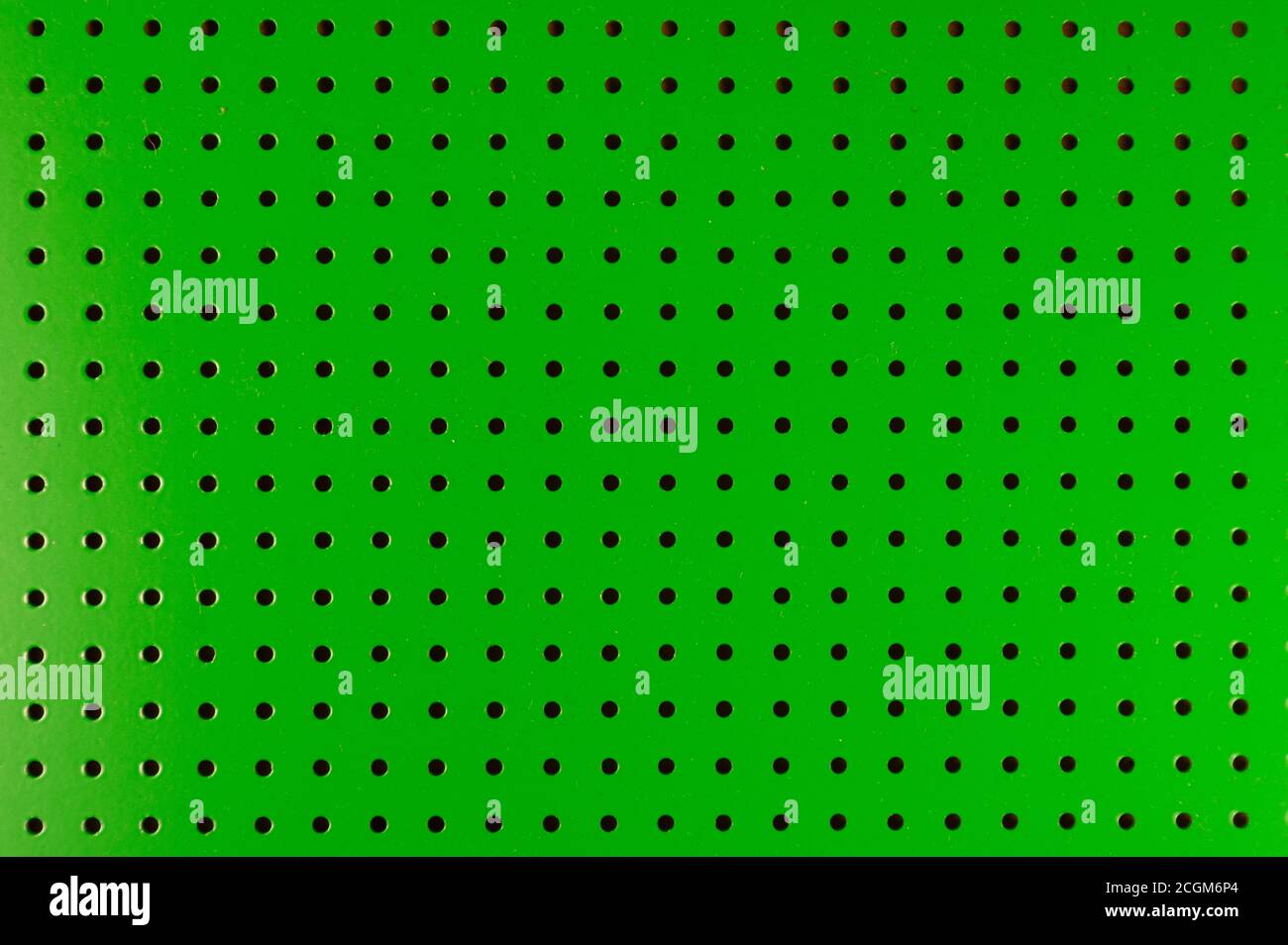 Green color metal background with holes Stock Photo - Alamy