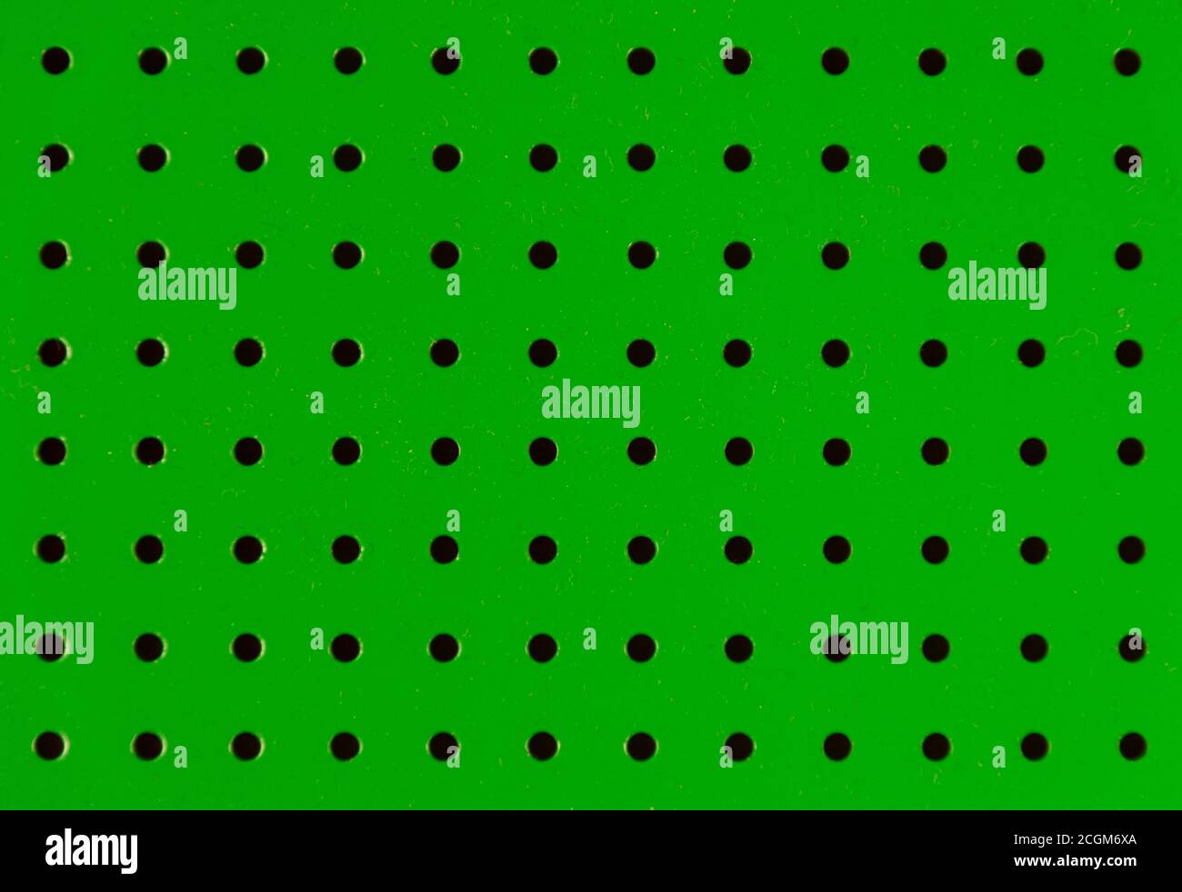 Green color metal background with holes Stock Photo - Alamy
