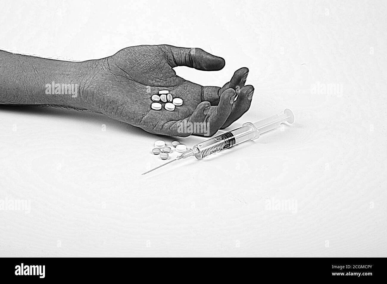 Drug addiction concept - passive hand with coat, pills and injection ...