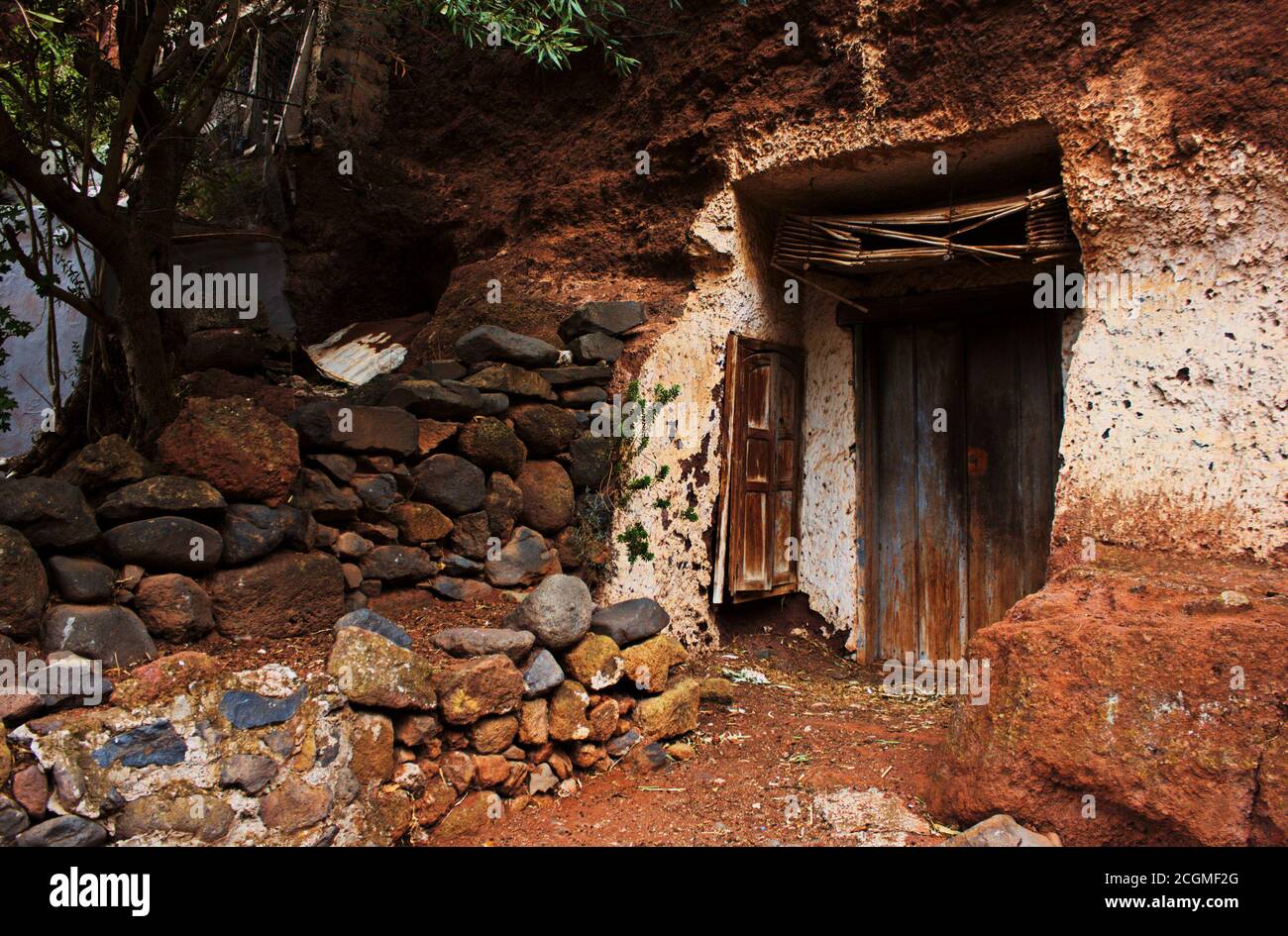 Old wrecked door of a house caved in a rock Stock Photo - Alamy