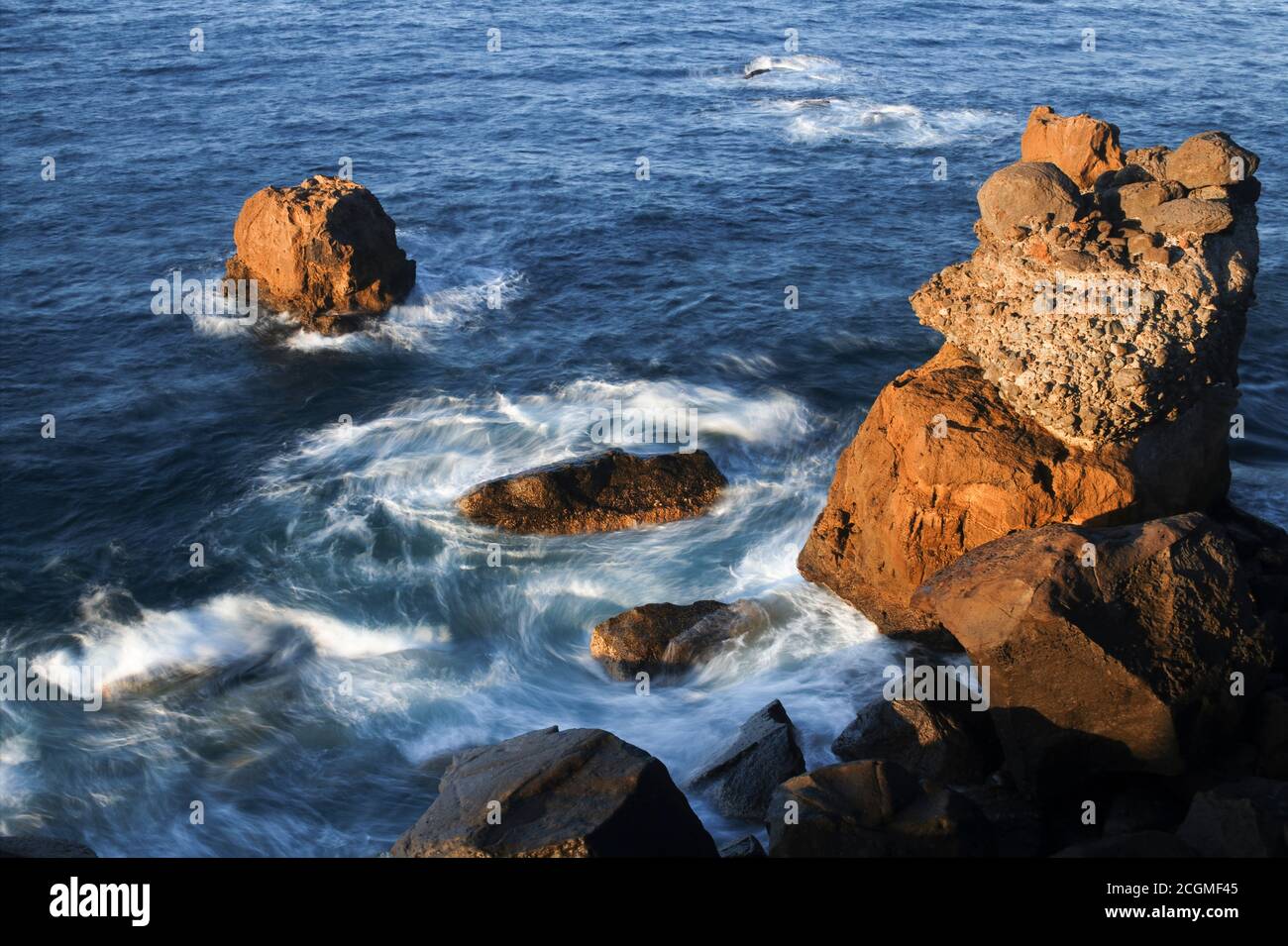 Ocean swirling around a rocky outcrop Stock Photo - Alamy