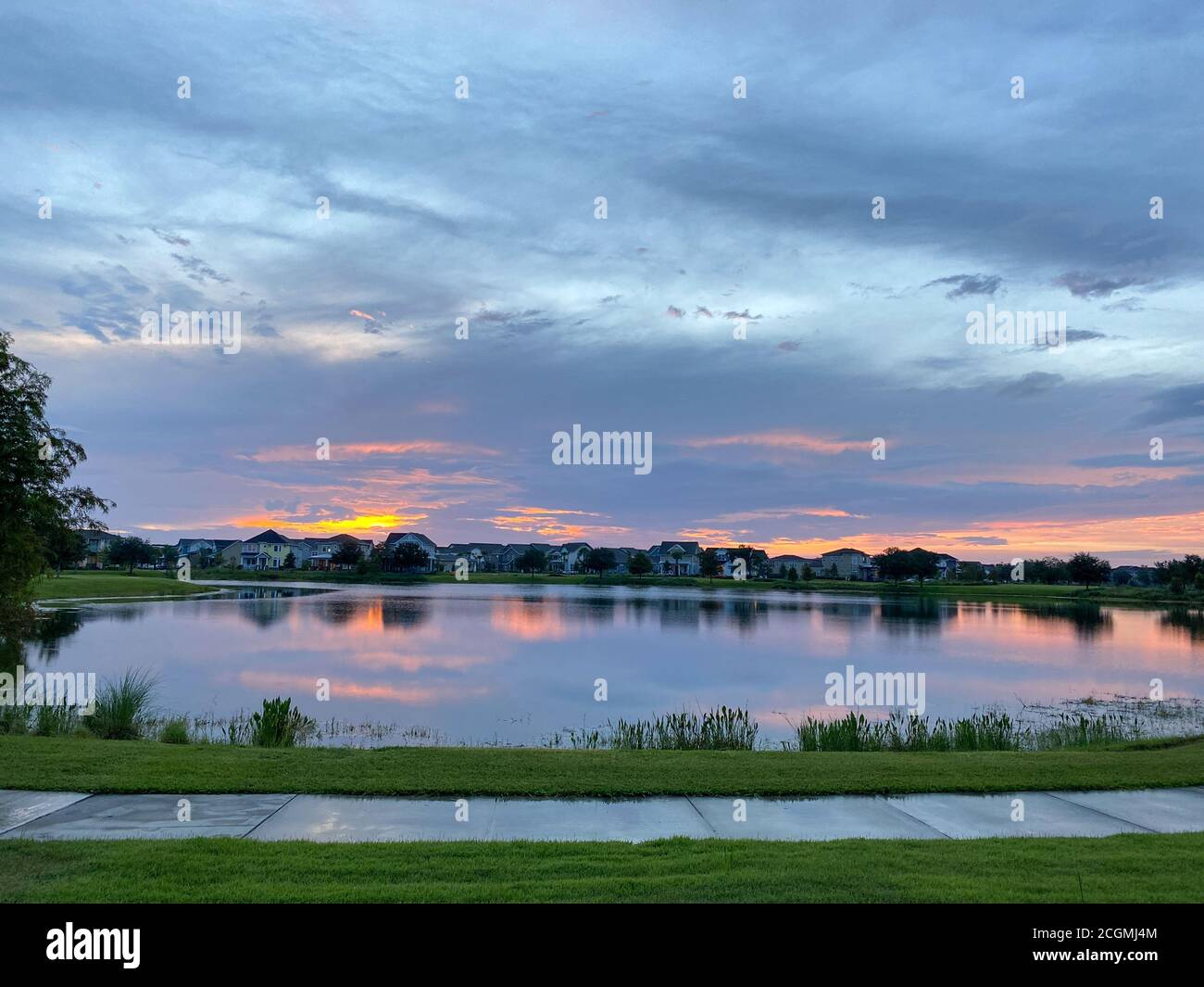 Beautiful pink, orange and blue sunset reflecting on a lake in a ...