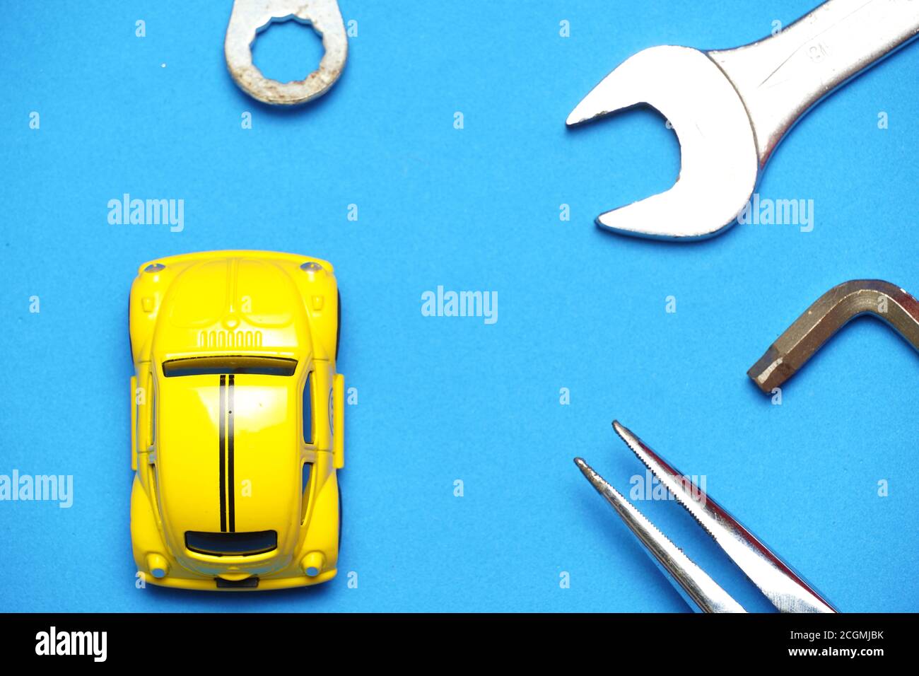top view of a car and tools on a blue colorful background. flat lay ...