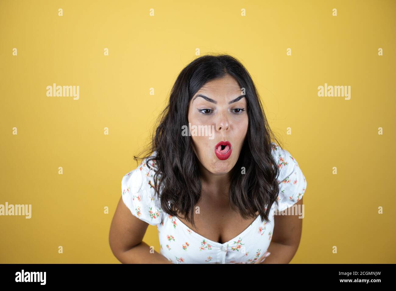 Beautiful woman over yellow background background having a nausea Stock ...